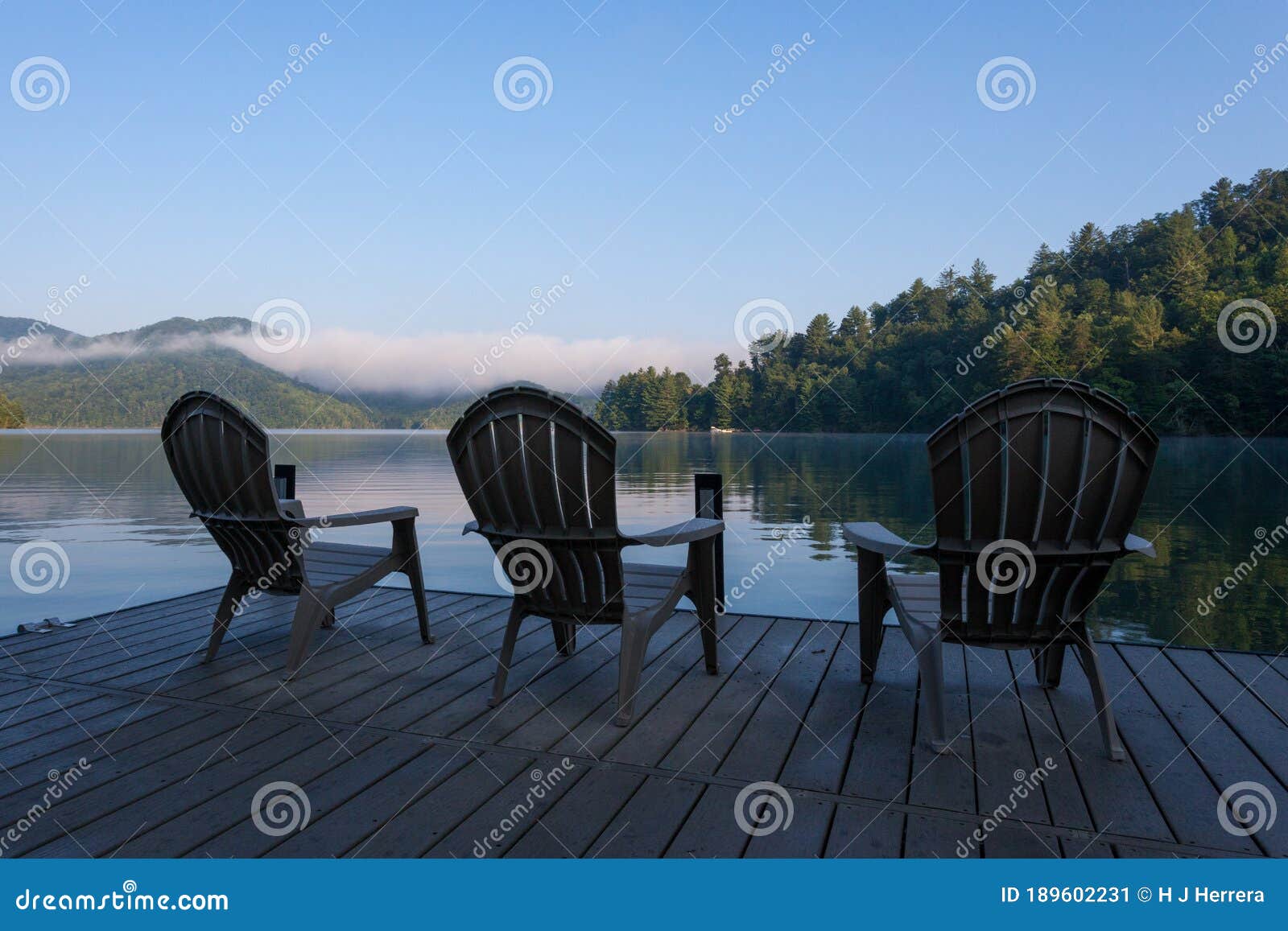 Adirondack Chairs on a Dock on a Lake in the Early Morning Stock Image ...