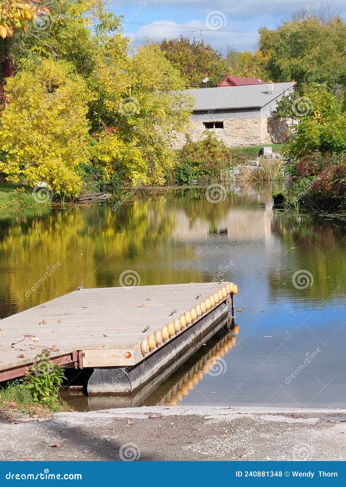 Dock on River with Stone Building in Background Stock Photo - Image of ...