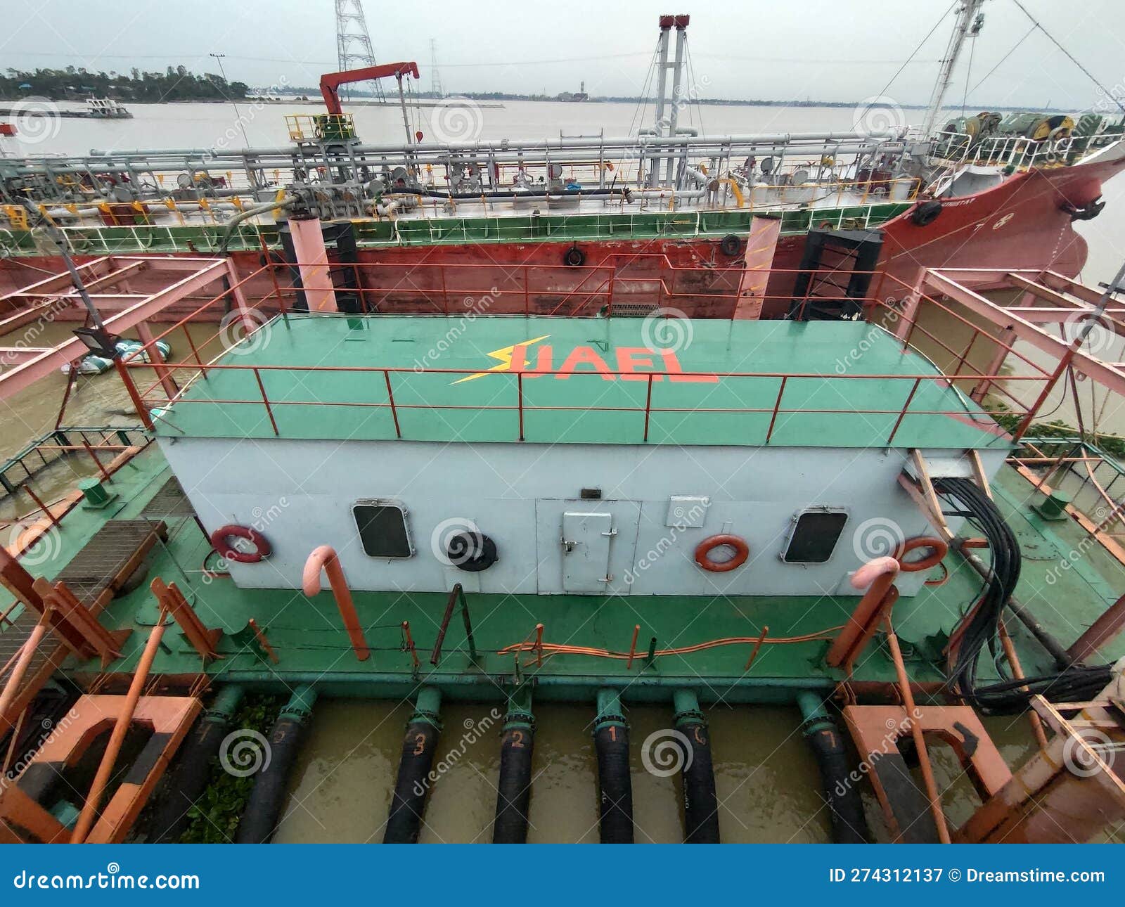 Docking Blue Colour Jetty with a Read Color Ship on the Beautiful River ...