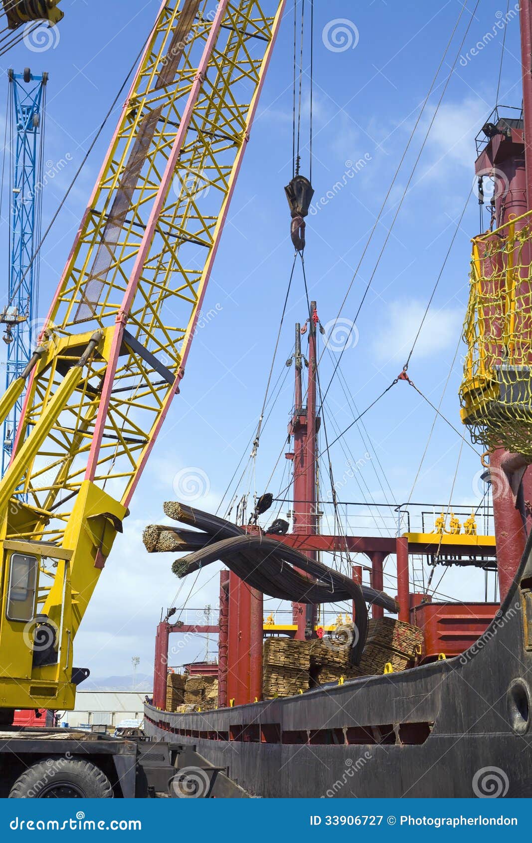 Dockside Crane Unloading Steel Rods from Freighter Stock Image - Image ...