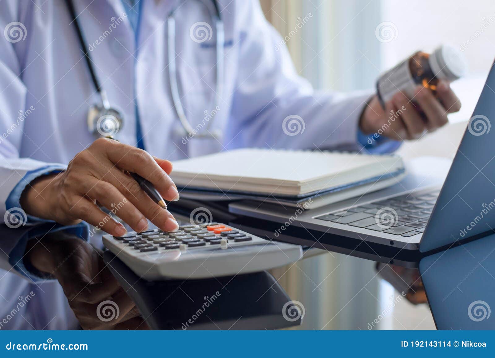 Doctor with Calculator and Medicine Bottle. Stock Photo - Image of form ...