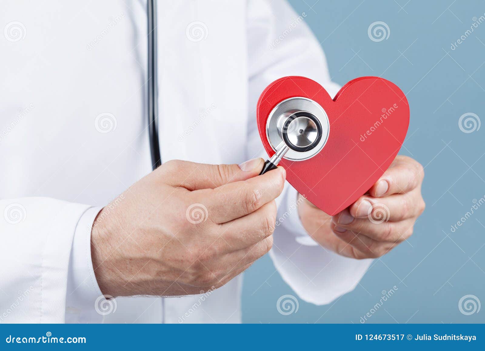 Doctor Cardiologist Holding A Red Heart In His Hands And Stethoscope