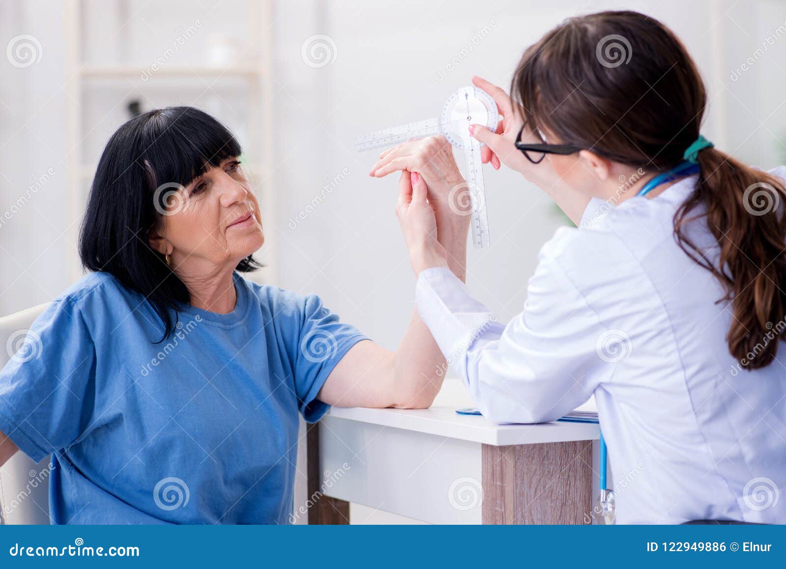 The Doctor Checking Flexibility with Goniometer Stock Photo - Image of ...
