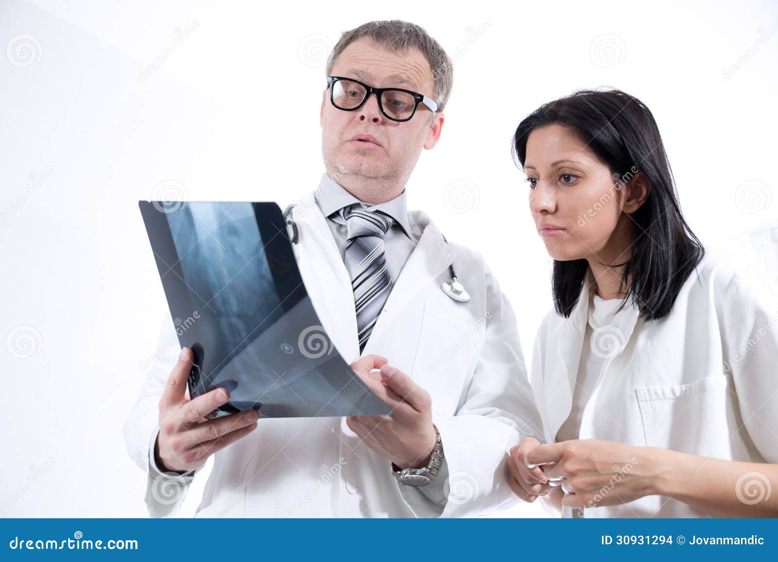 Doctor Checking X-ray Image Stock Photo - Image of radiation, medical ...