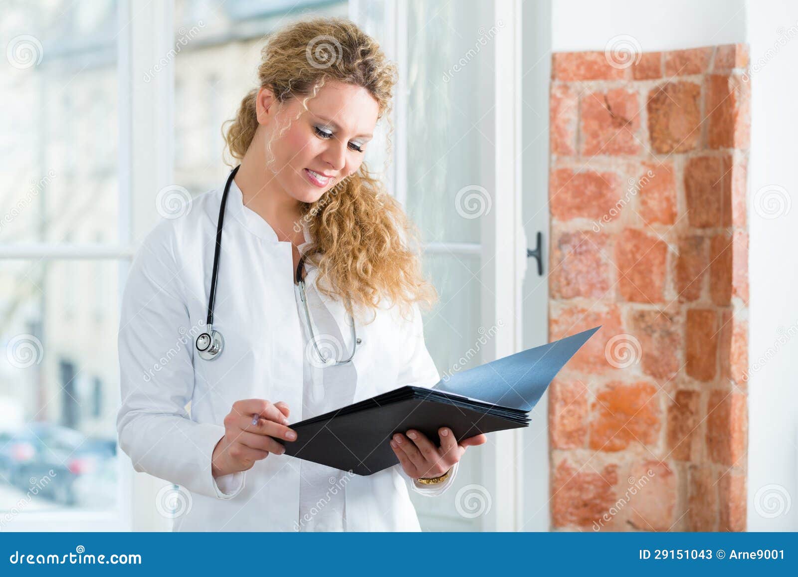 Doctor in Clinic Reading a File Stock Image - Image of doctors ...