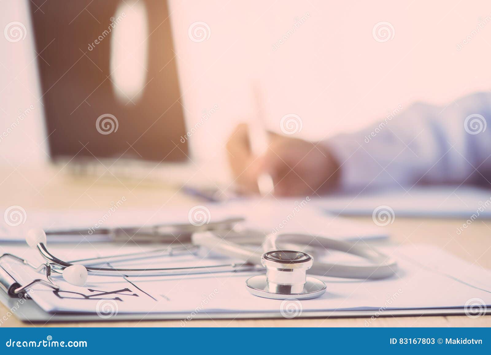 Doctor Completing a Medical Claim Form by Stethoscope Stock Image ...