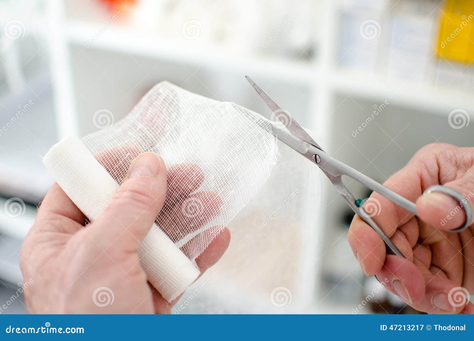 Doctor cutting a bandage stock image. Image of medicine - 47213217