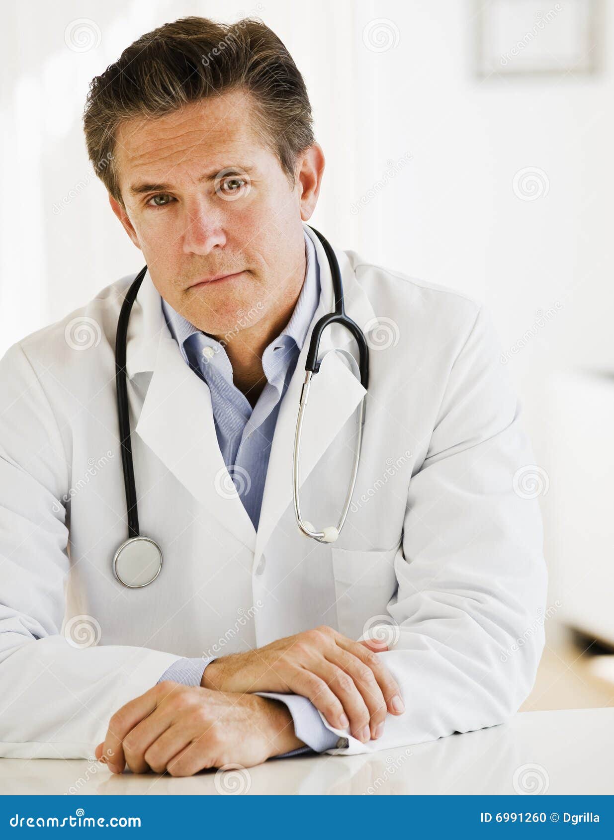 Doctor at desk in office stock photo. Image of holding - 6991260