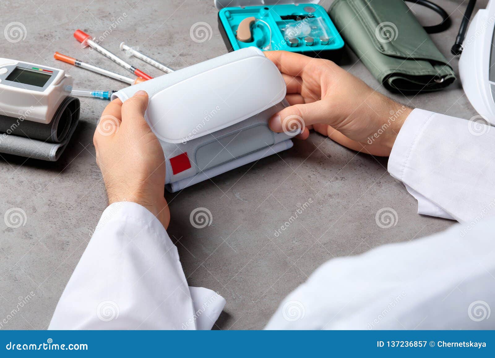 Doctor with Digital Pressure Meter and Different Medical Objects at ...