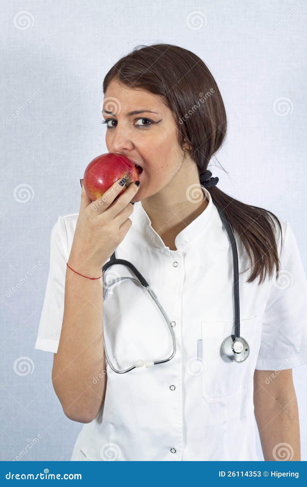 Doctor eating an apple stock image. Image of surgeon - 26114353