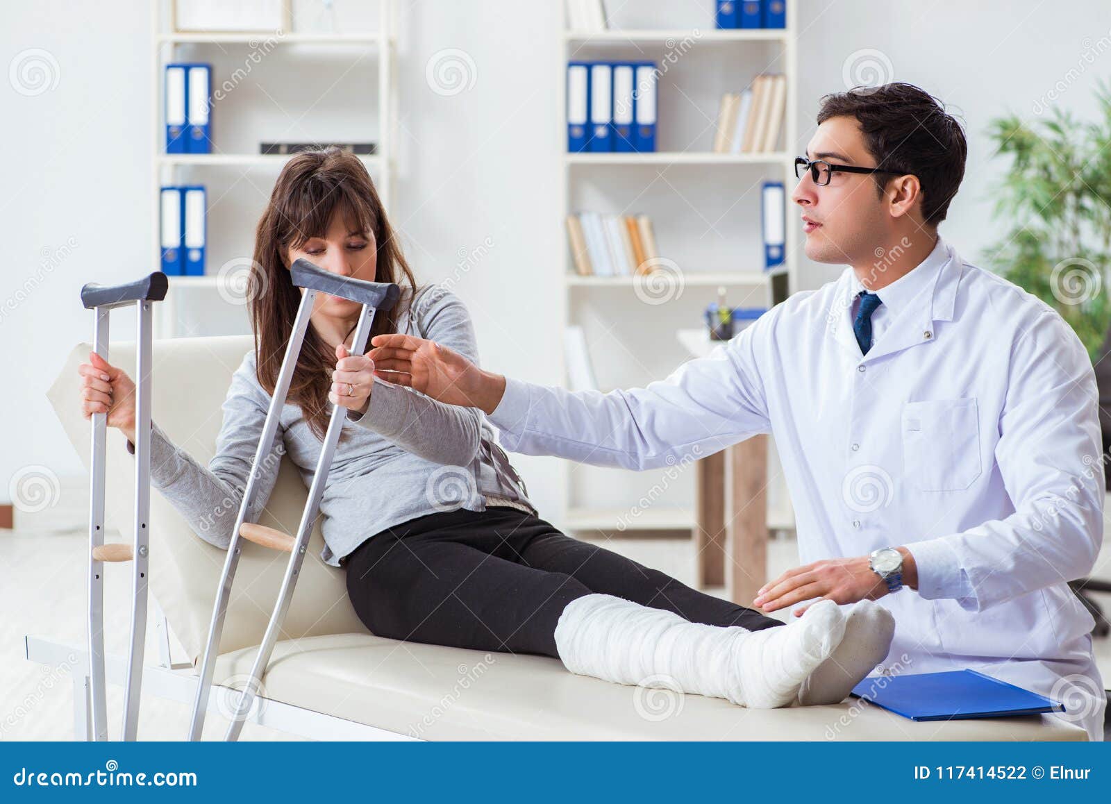 The Doctor Examining Patient with Broken Leg Stock Photo - Image of ...