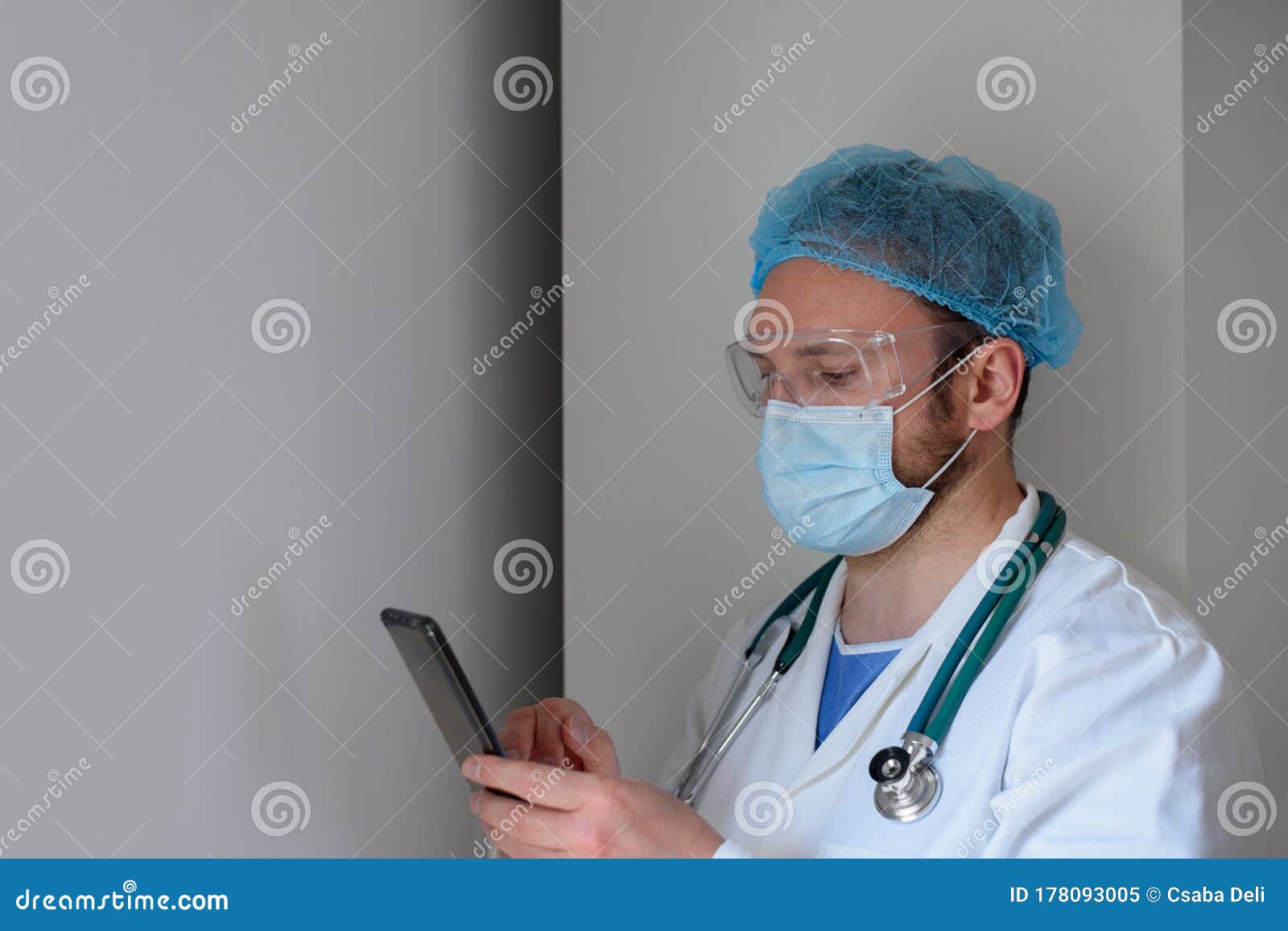 Doctor in Face Mask Using Smartphone in the Hospital Stock Image ...