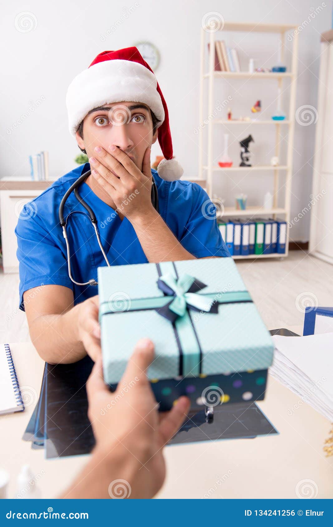 The Doctor with Gift Box in the Hospital Stock Photo - Image of giving ...