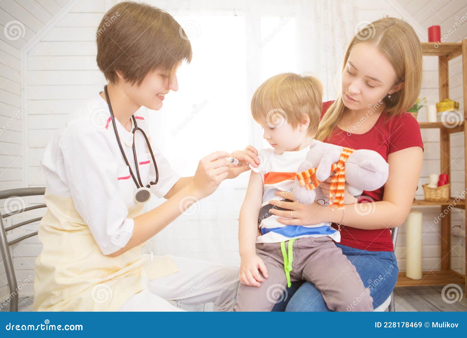 A Doctor Giving a Child an Injection at Home Stock Image - Image of ...