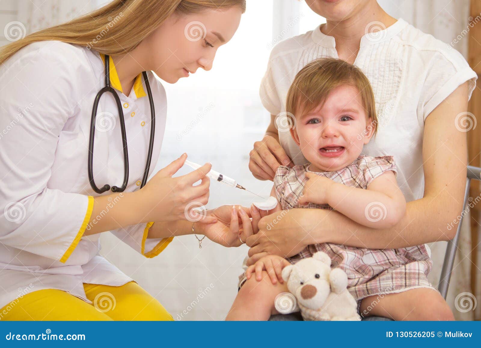 A Doctor Giving a Crying Child an Injection at Home Stock Image - Image ...
