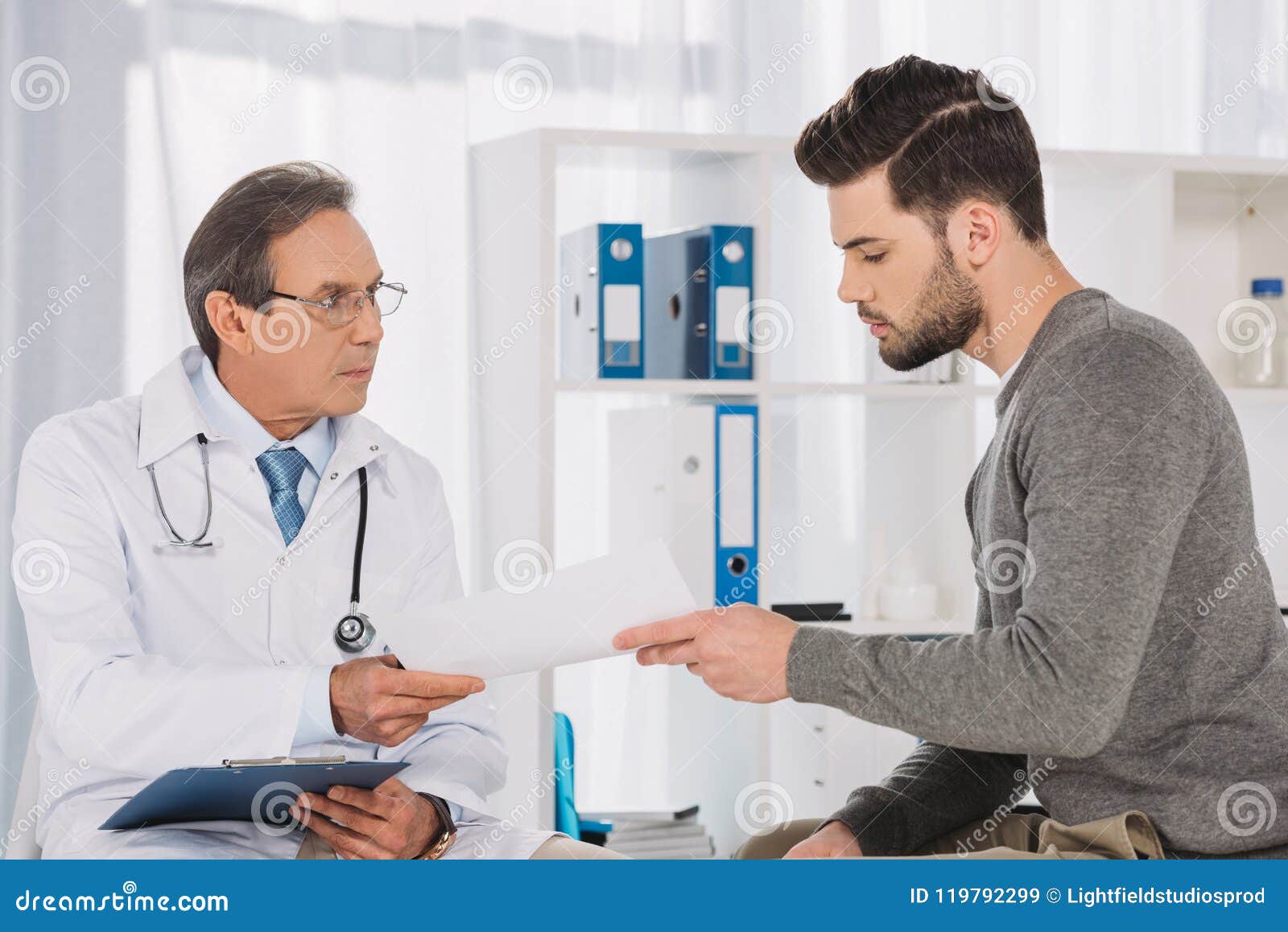Doctor giving documents to stock image. Image of handsome - 119792299
