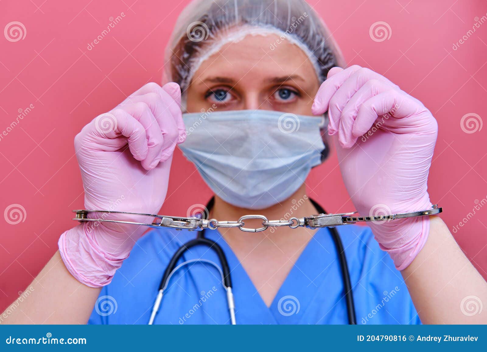 Doctor Hands in Handcuffs on Pink Background, Close Up. Young Woman ... Doctor Hands in Handcuffs on Pink Background, Close Up. Young Woman ...