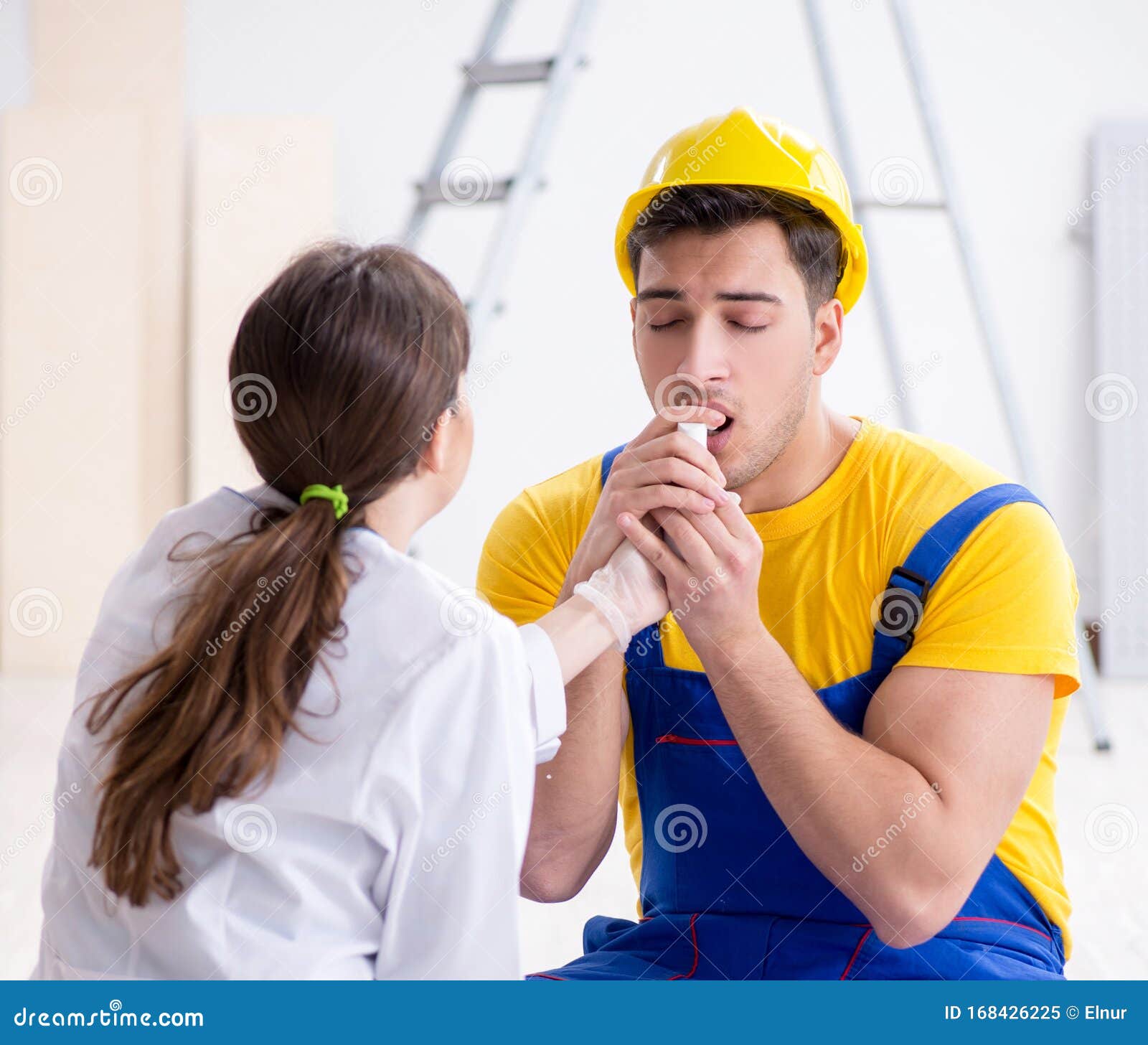 Doctor Helping Injured Worker at Construction Site Stock Image - Image ...