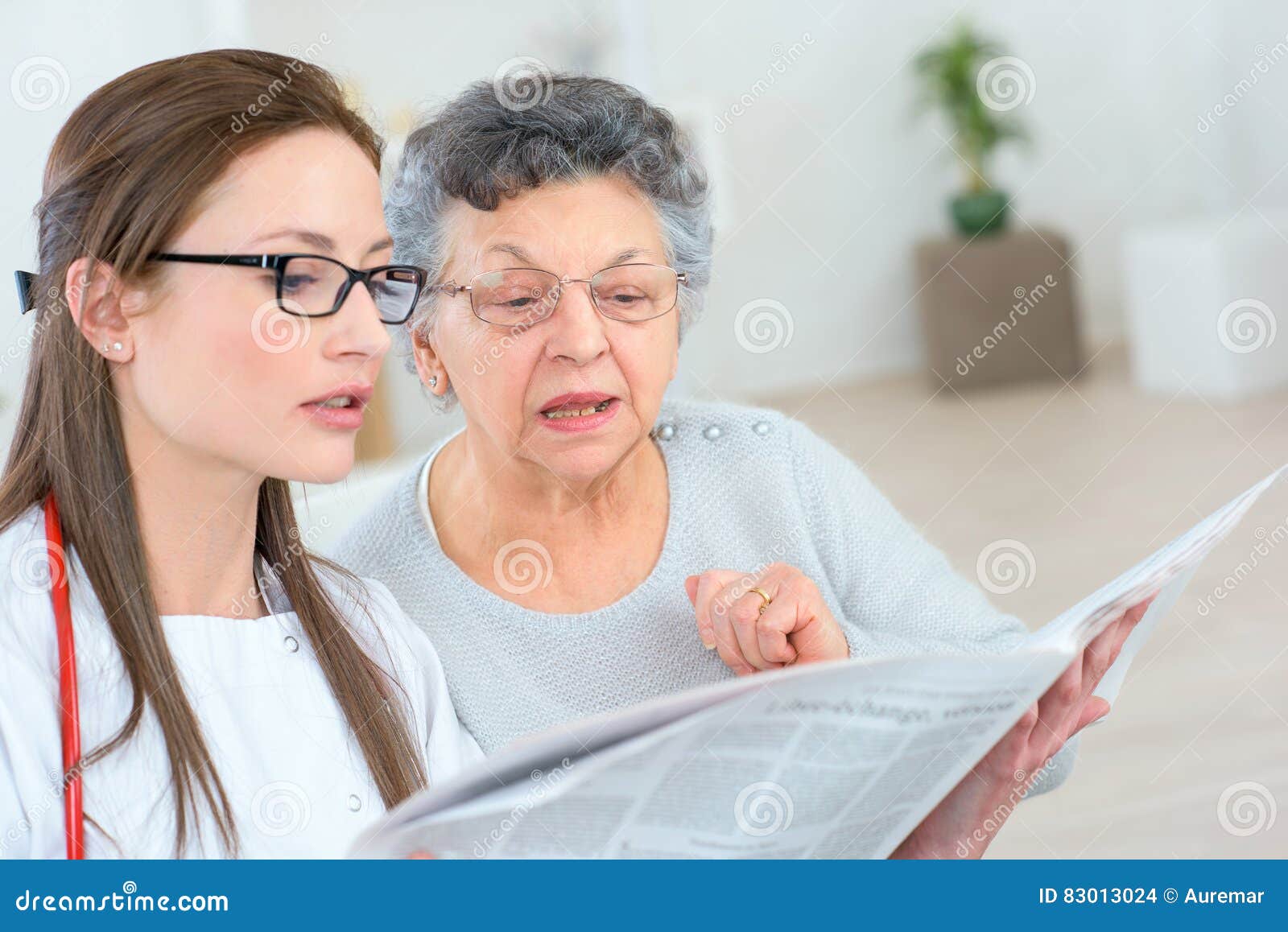 Doctor Helping Patient To Read Stock Photo - Image of person, newspaper ...