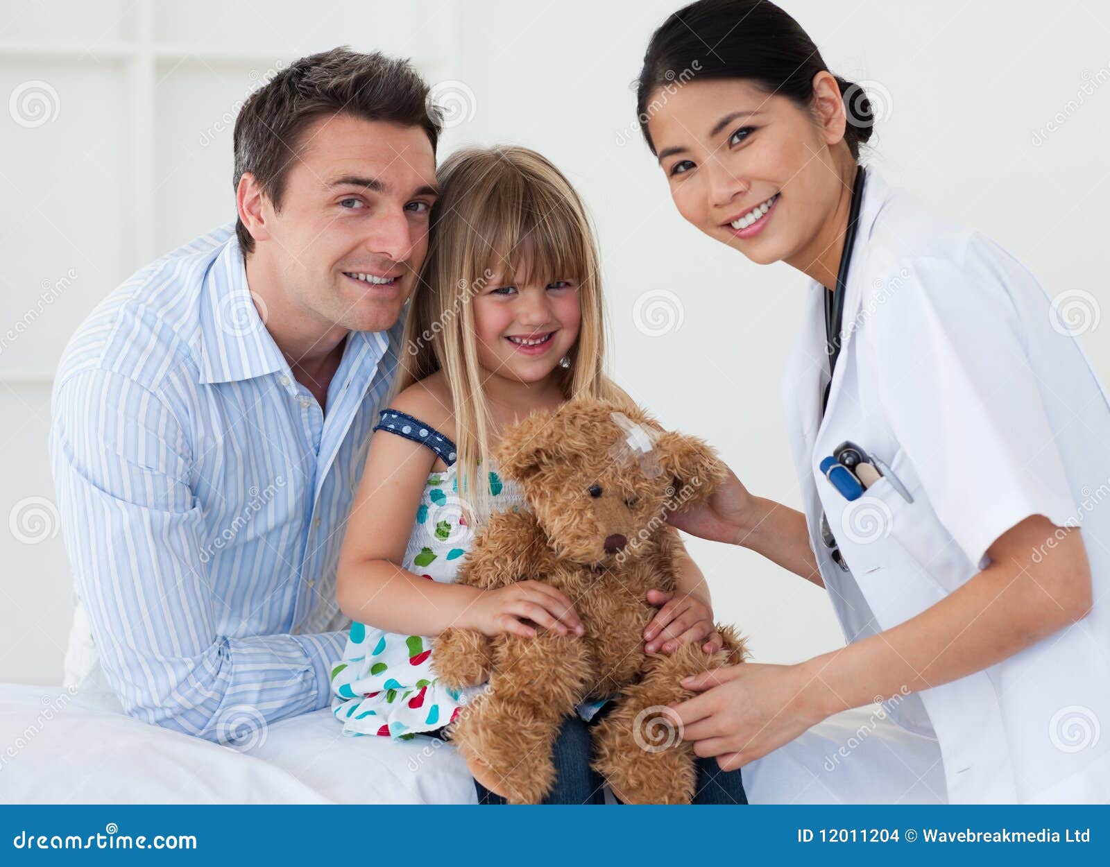 A Doctor and Her Patient Examining a Teddy Bear Stock Photo - Image of ...