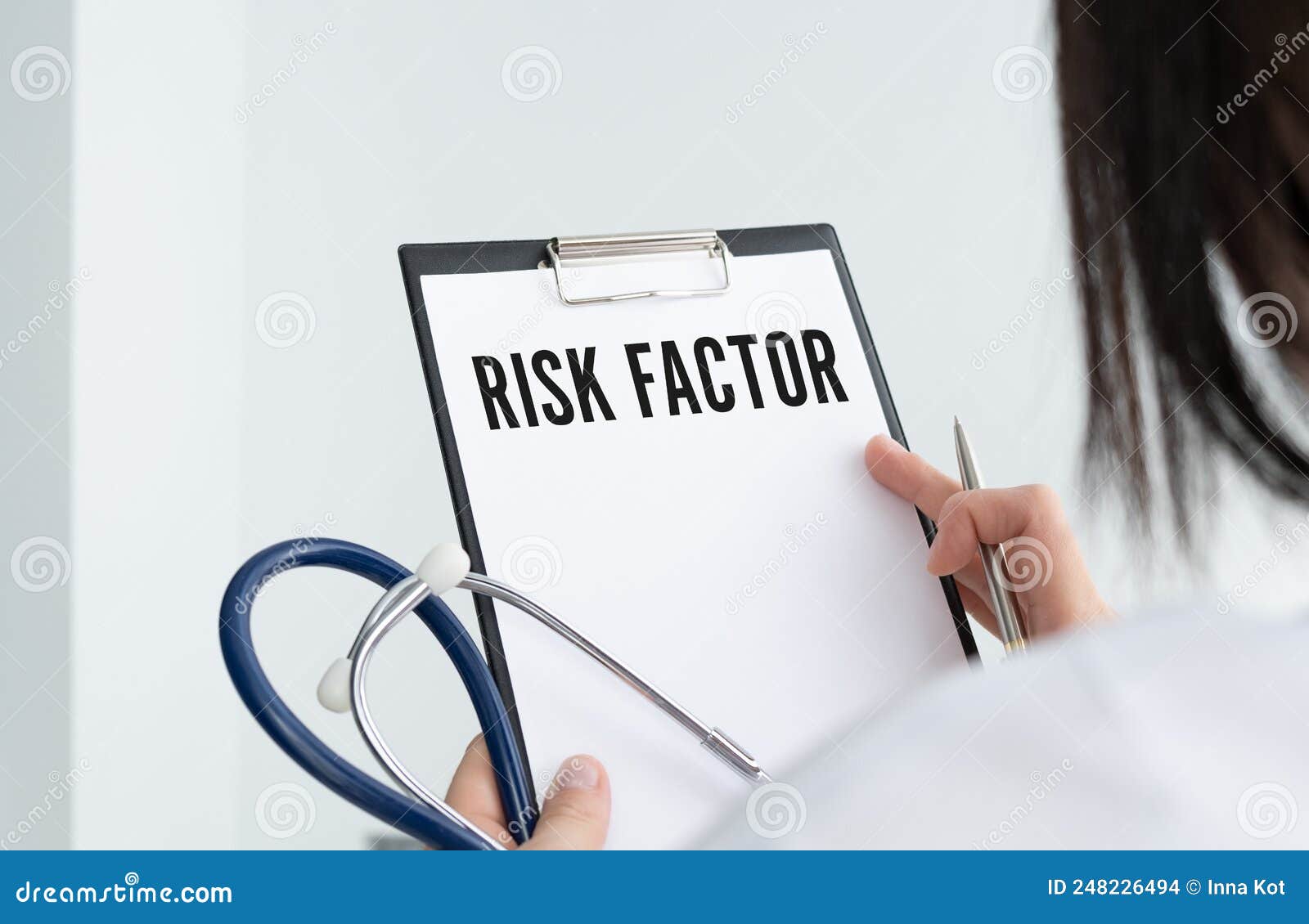 Doctor Holding a Card with Text RISK FACTOR, Medical Concept Stock ...