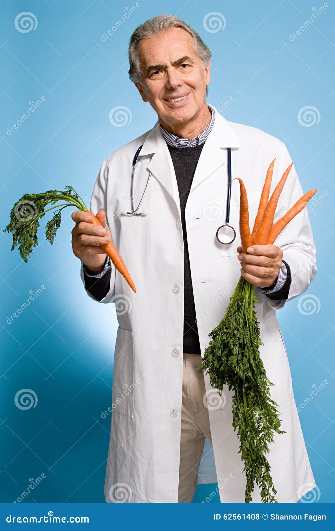 Doctor holding carrots stock photo. Image of blue, adult - 62561408