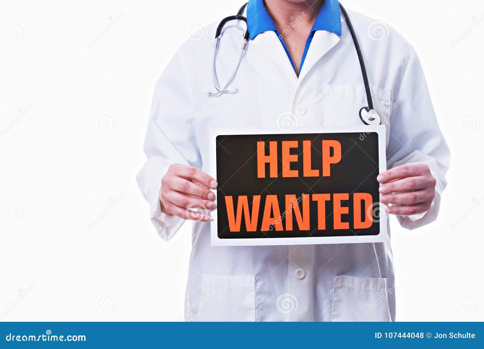 A Doctor Holding a Help Wanted Sign Stock Photo - Image of medical ...