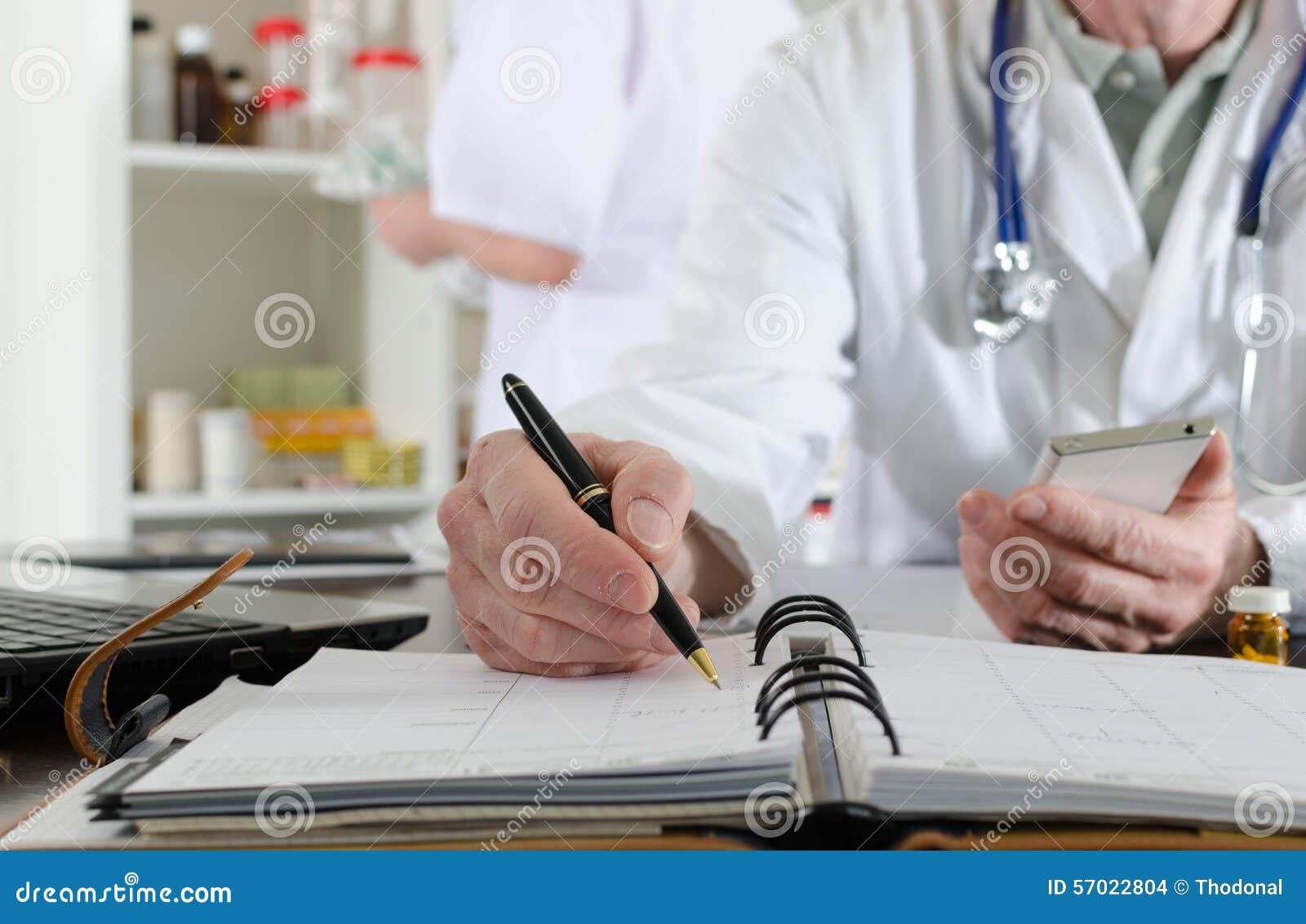 Doctor Holding a Smartphone and Taking Notes Stock Photo - Image of ...