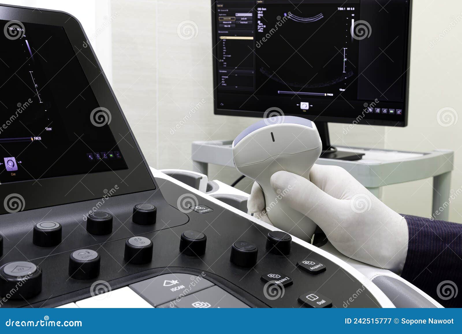 A Doctor Holding an Ultrasound Probe by the Sonography Machine Stock ...