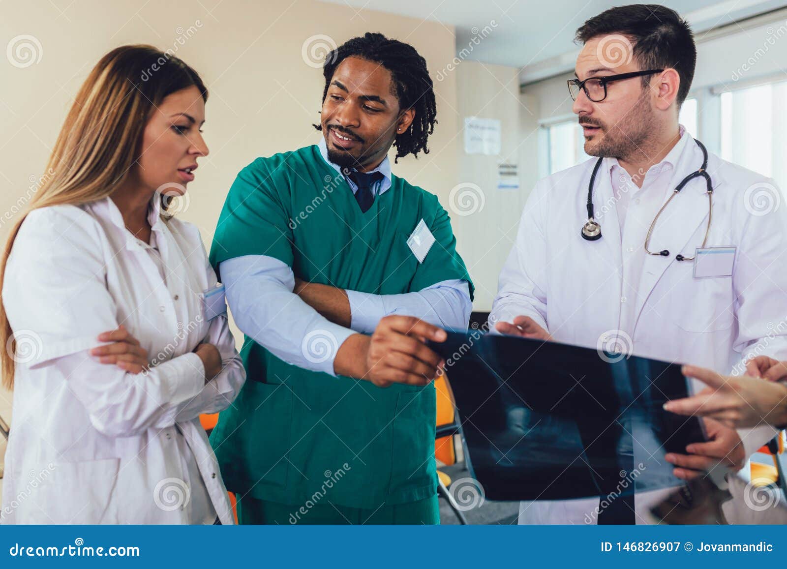 Doctor Holding Up an X-ray with Fellow Doctors Stock Image - Image of ...