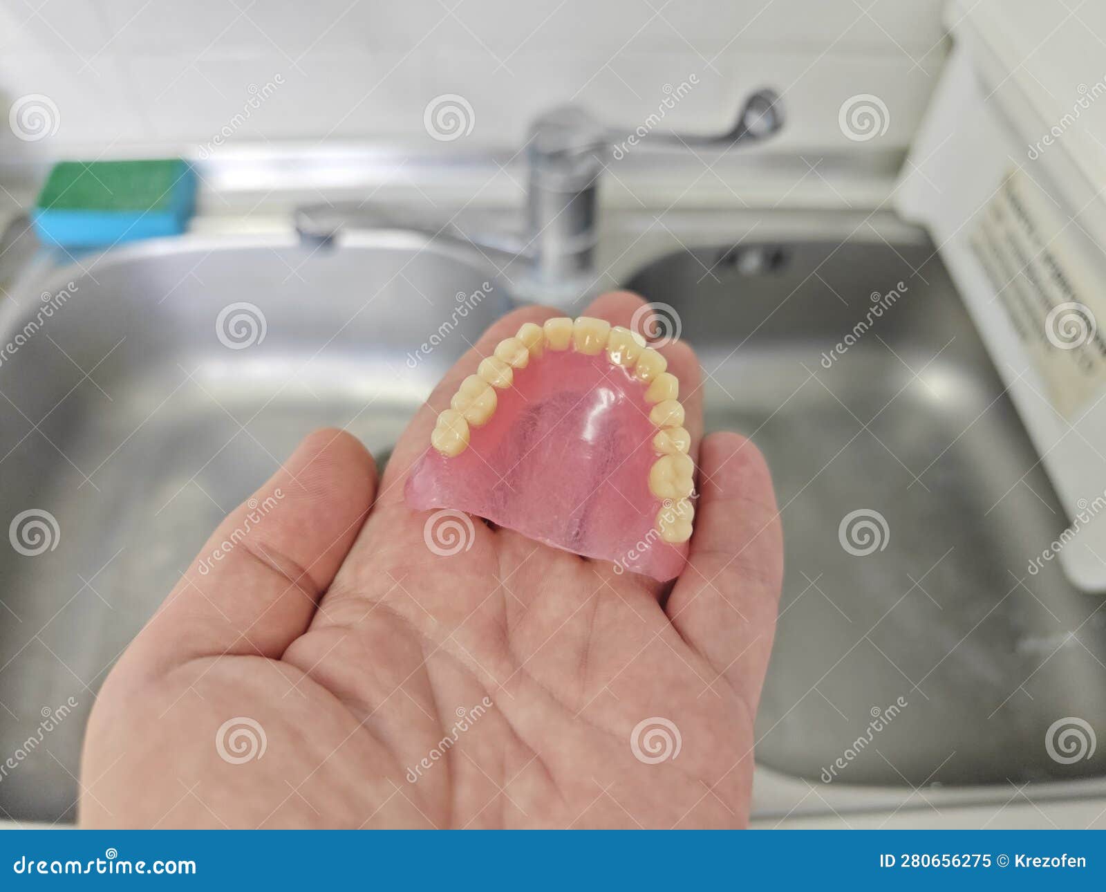 The Doctor Holds in His Hands and Demonstrates a Removable Denture ...