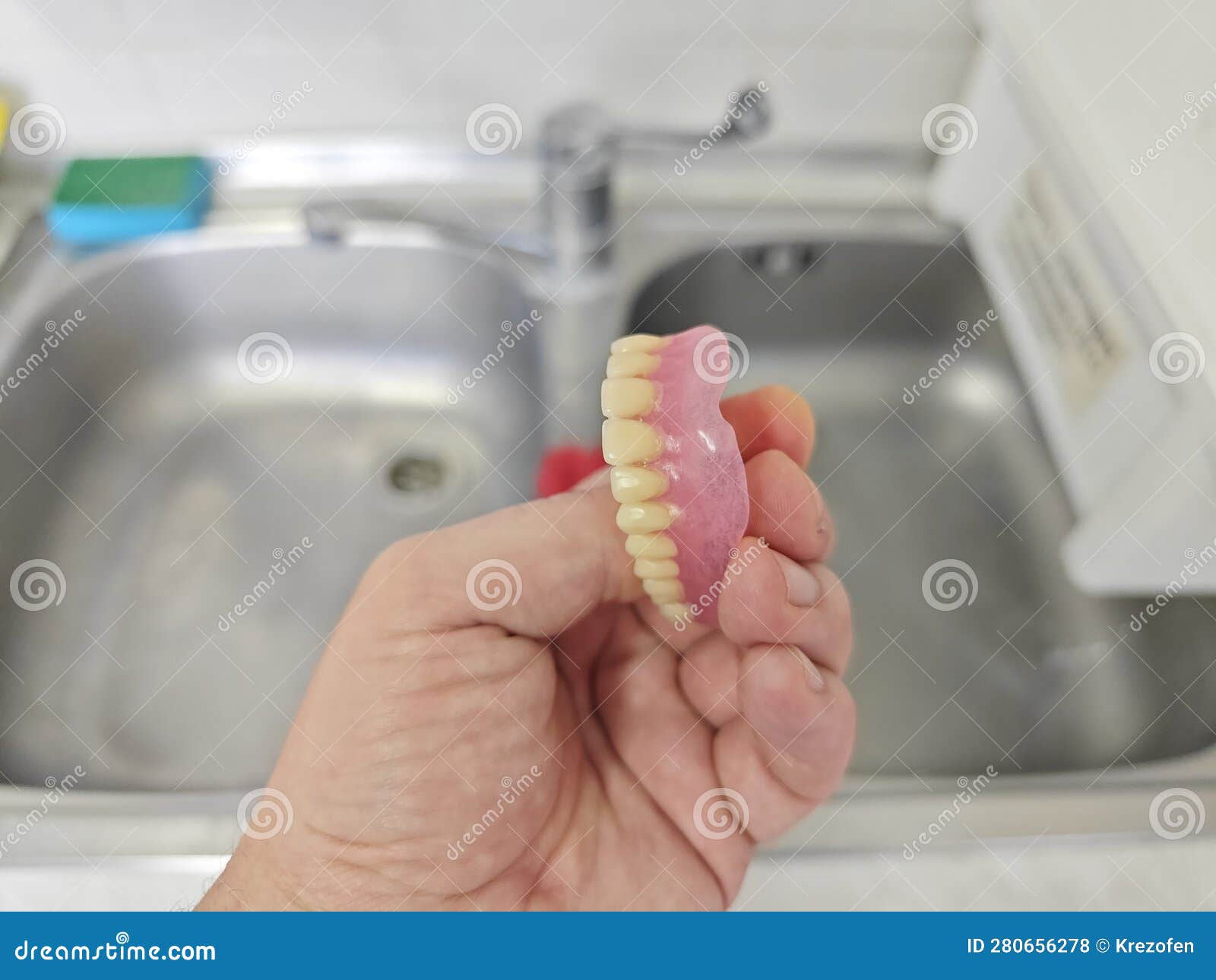 The Doctor Holds in His Hands and Demonstrates a Removable Denture ...