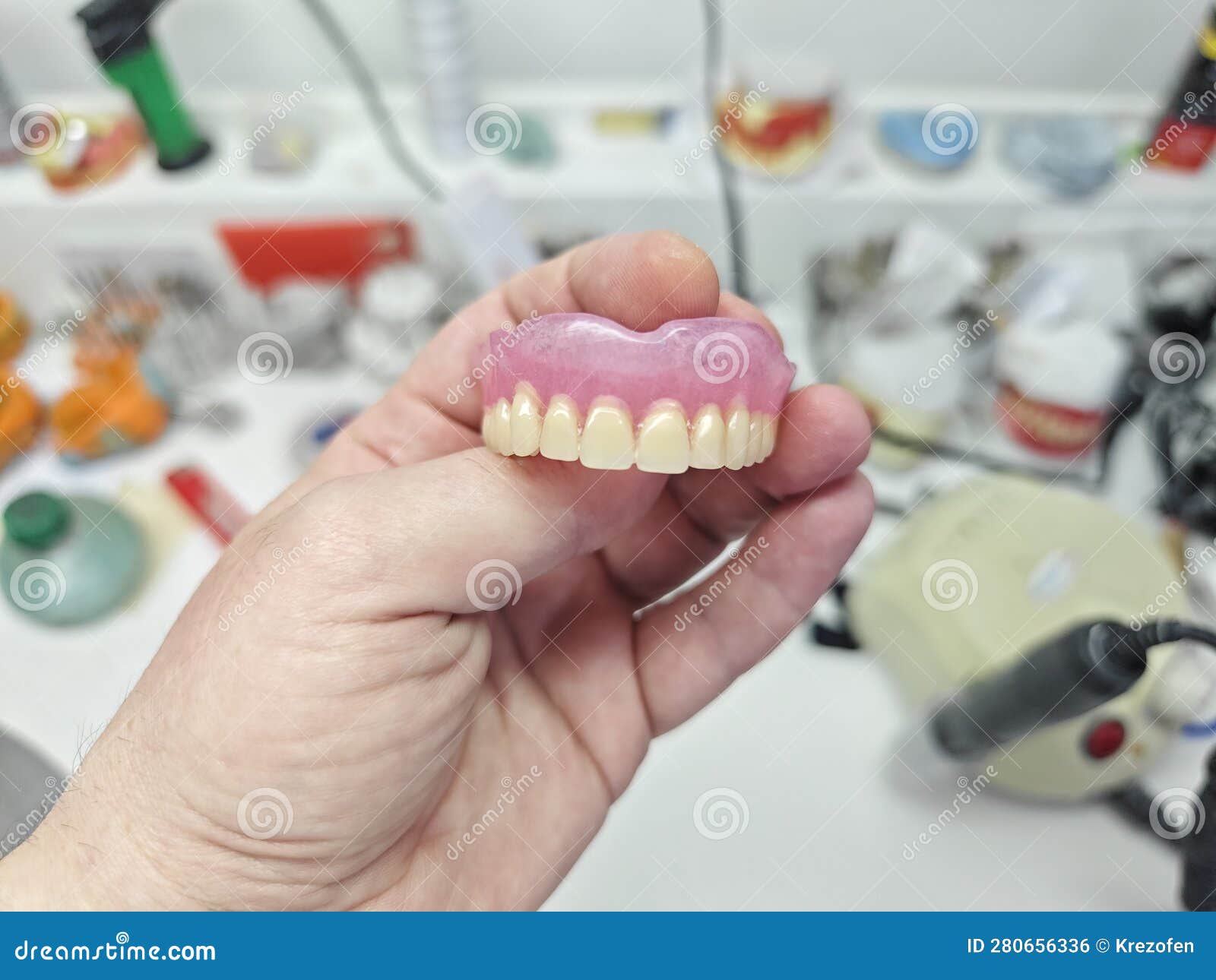 The Doctor Holds in His Hands and Demonstrates a Removable Denture ...