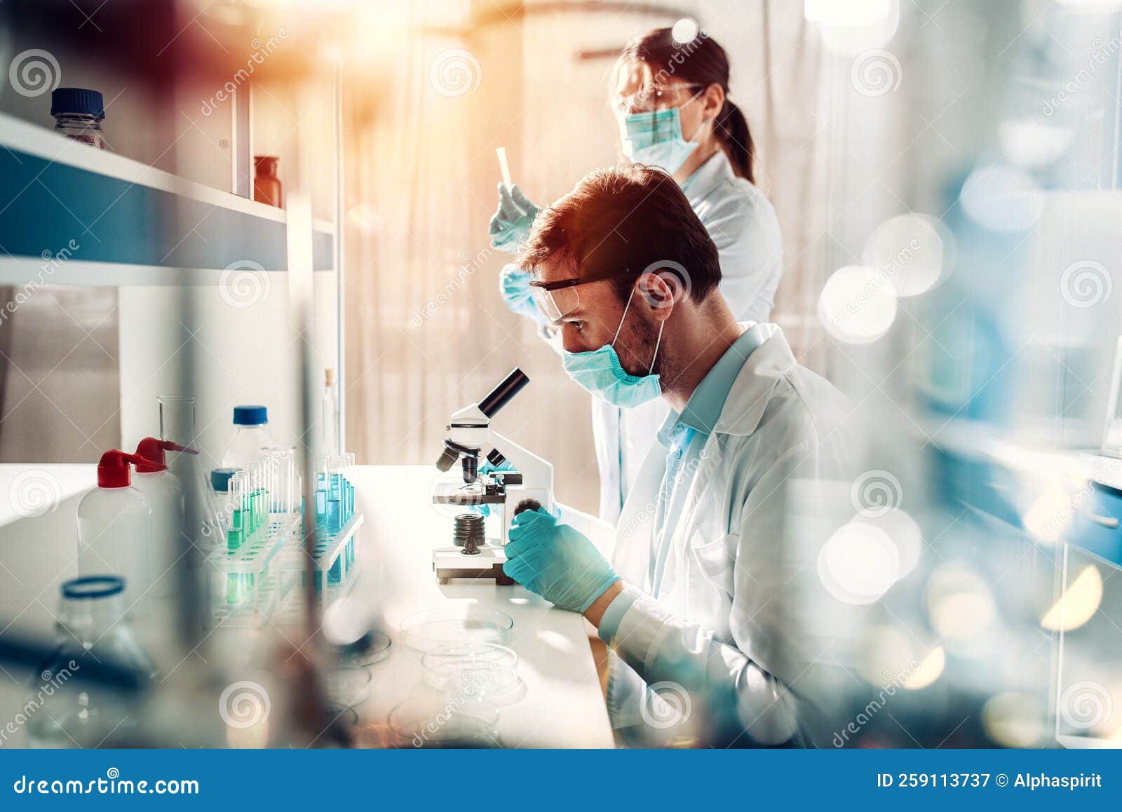 Doctor in the Laboratory Analyzes Samples of Codiv-9 Under a Microscope ...