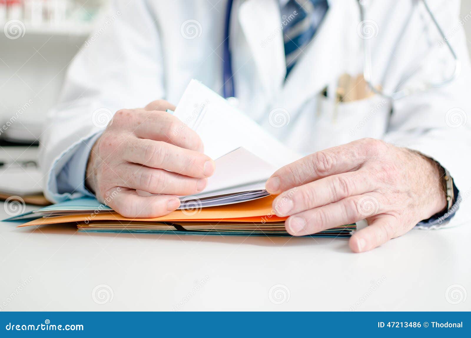 Doctor looking for a file stock photo. Image of medicine - 47213486
