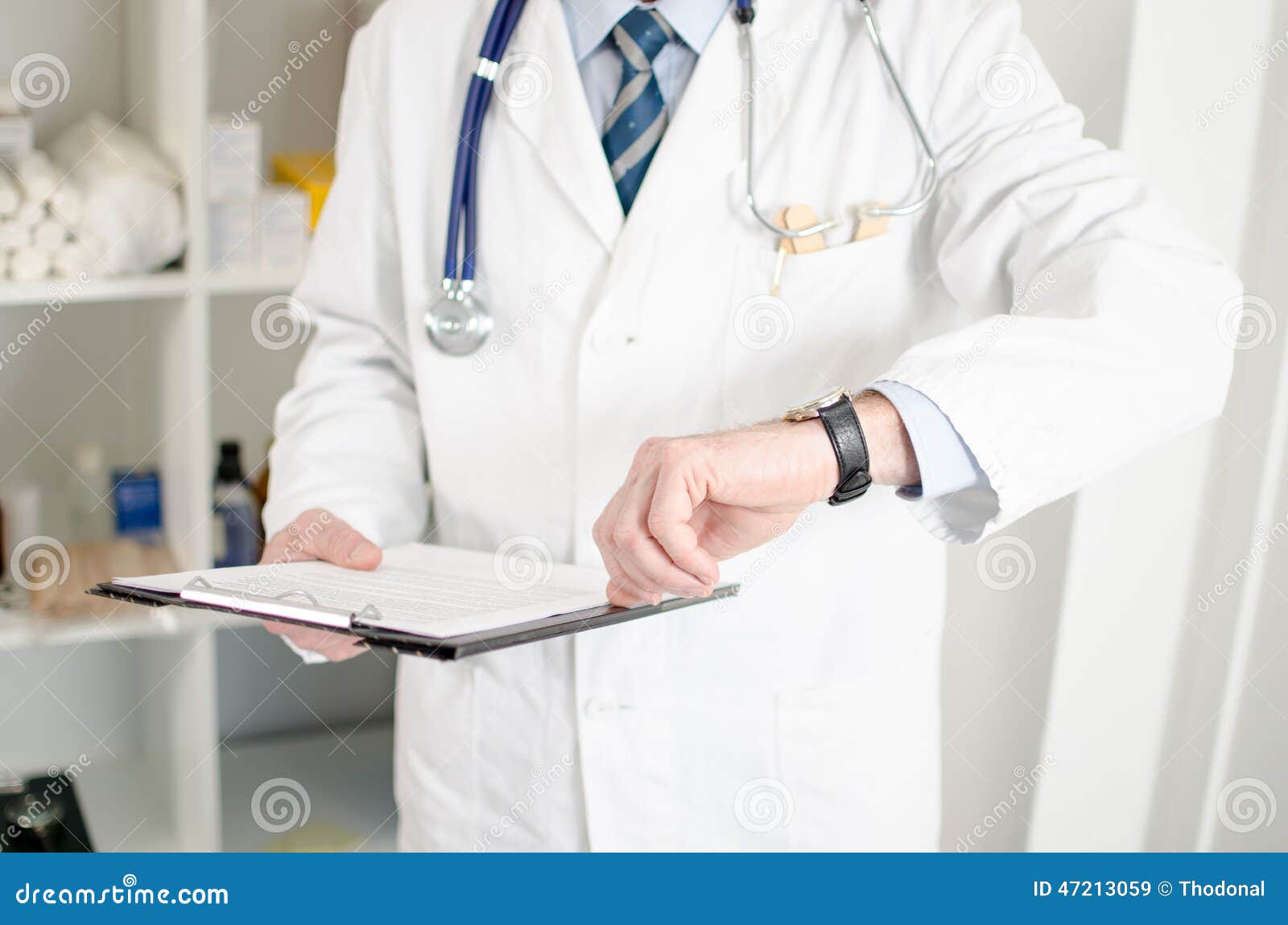 Doctor Looking at His Watch Stock Image - Image of instrument, coat ...