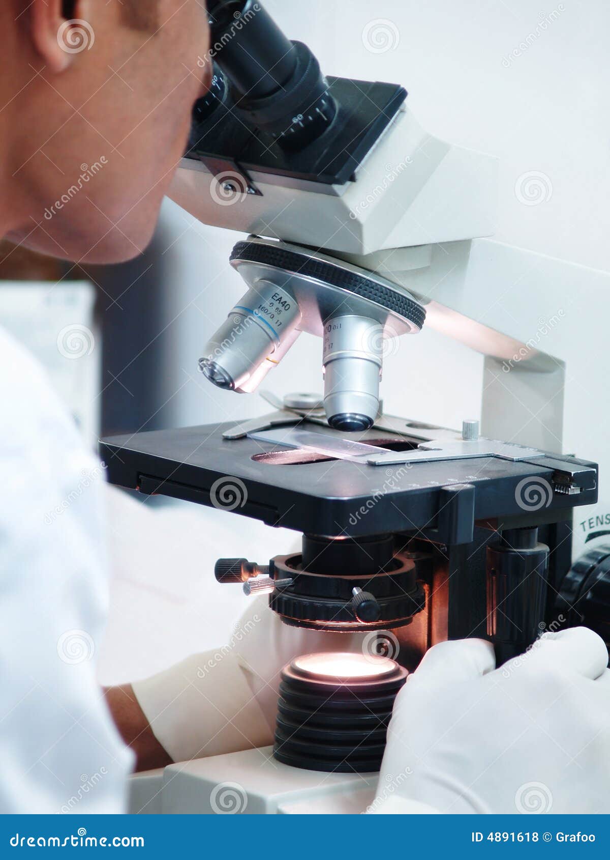 Doctor Looking into Microscope Stock Photo - Image of microscope ...