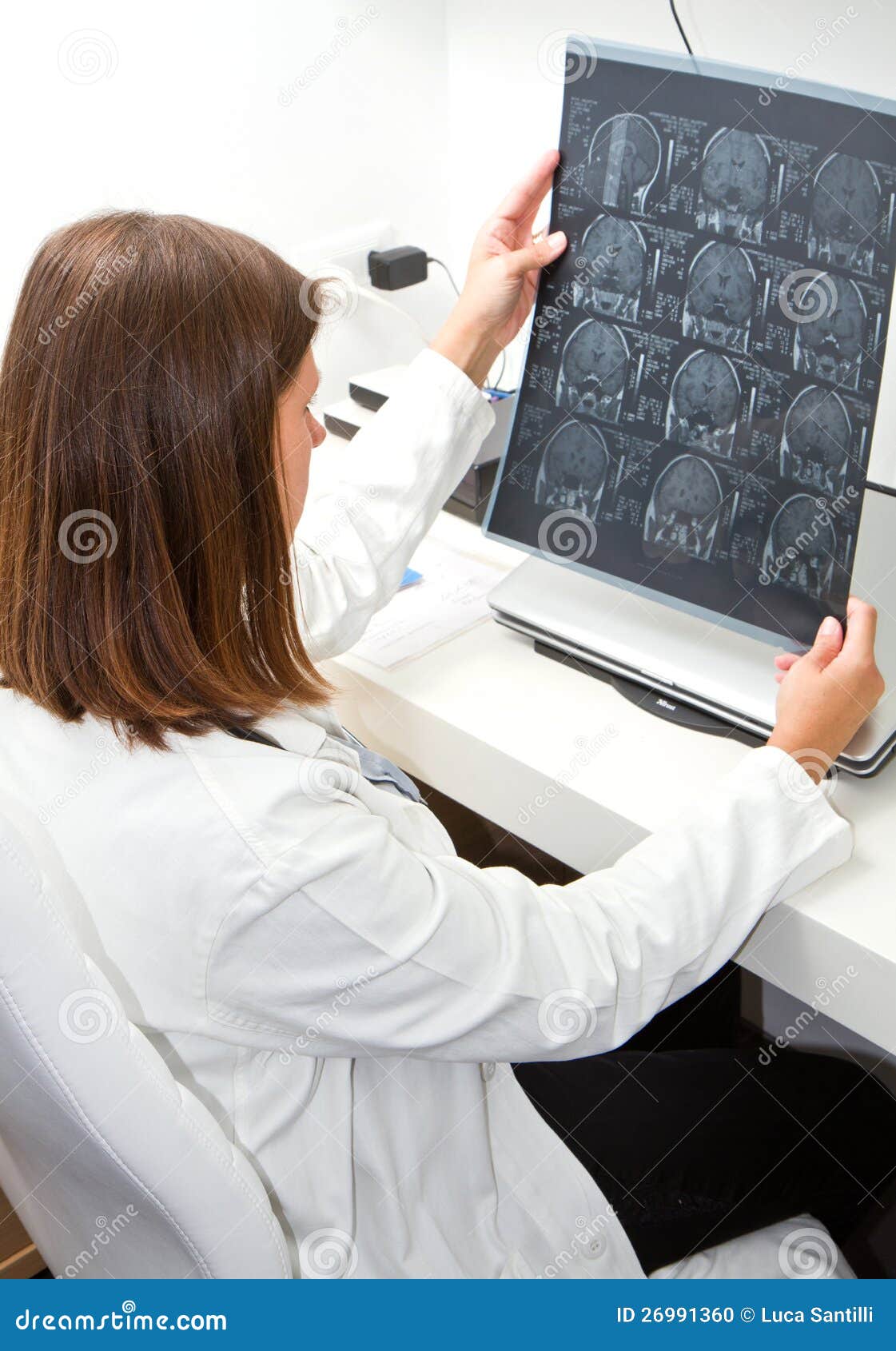 Doctor looking at x-ray stock photo. Image of practitioner - 26991360