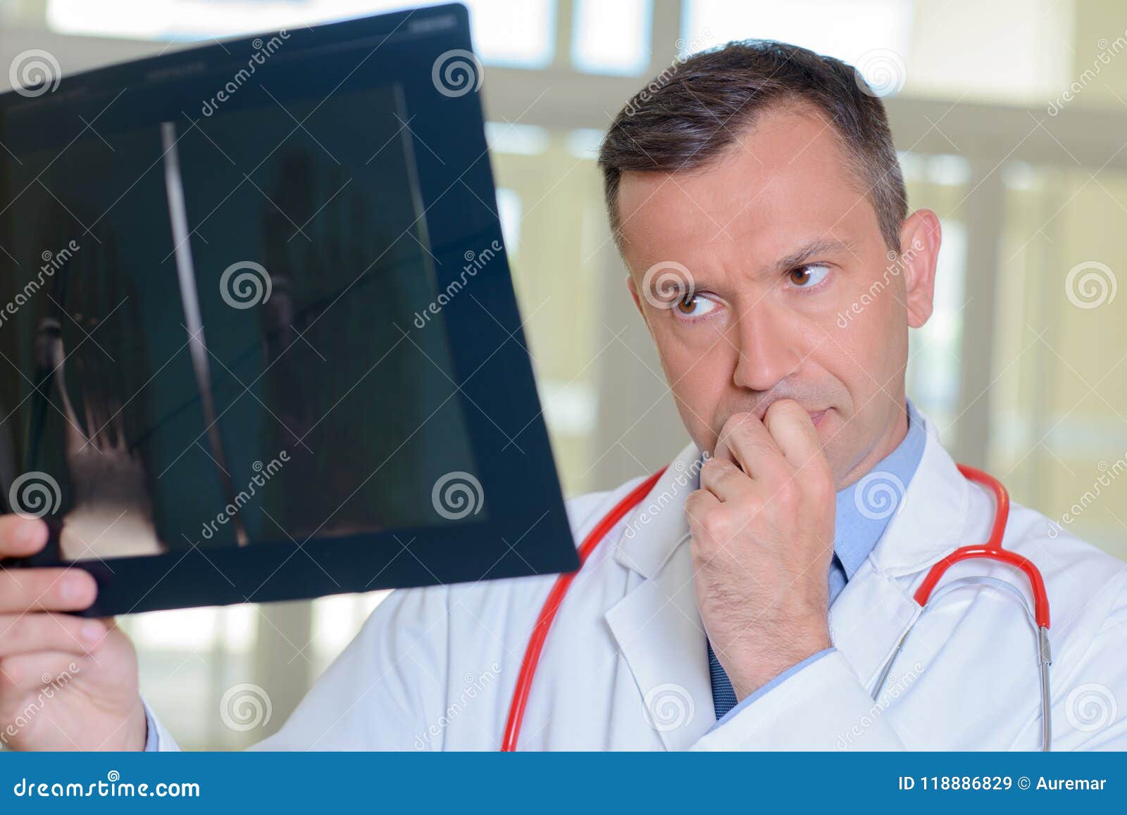 Doctor Looking at X Ray with Concerned Expression Stock Image - Image ...