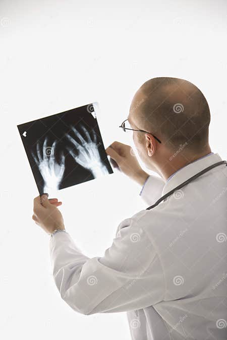 Doctor looking at xrays. stock photo. Image of healthcare - 2431966