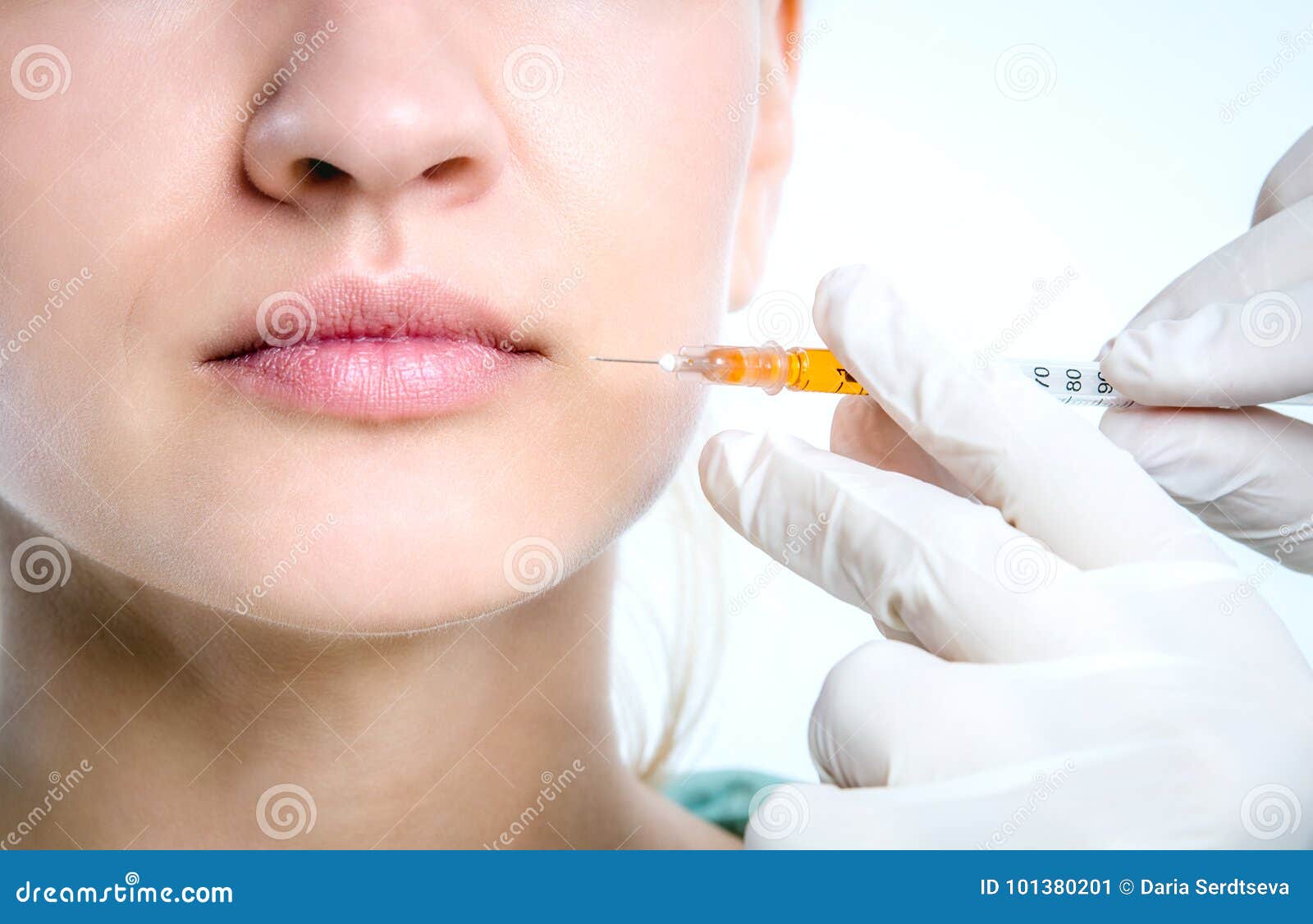 The Doctor Makes an Injection into the Lips of a Patient. Stock Image ...
