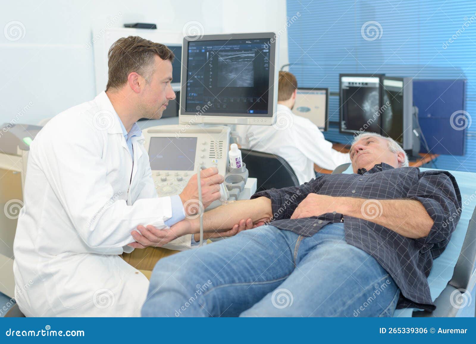 Doctor Making Ultrasound To Man Stock Photo - Image of professional ...