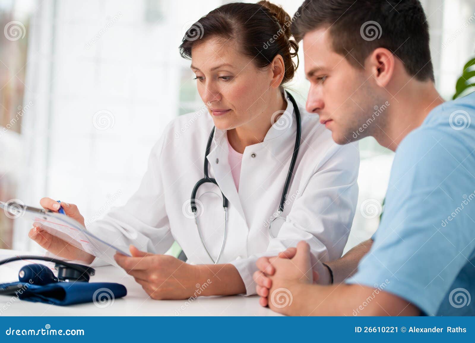 Doctor with male patient stock image. Image of explaining - 26610221