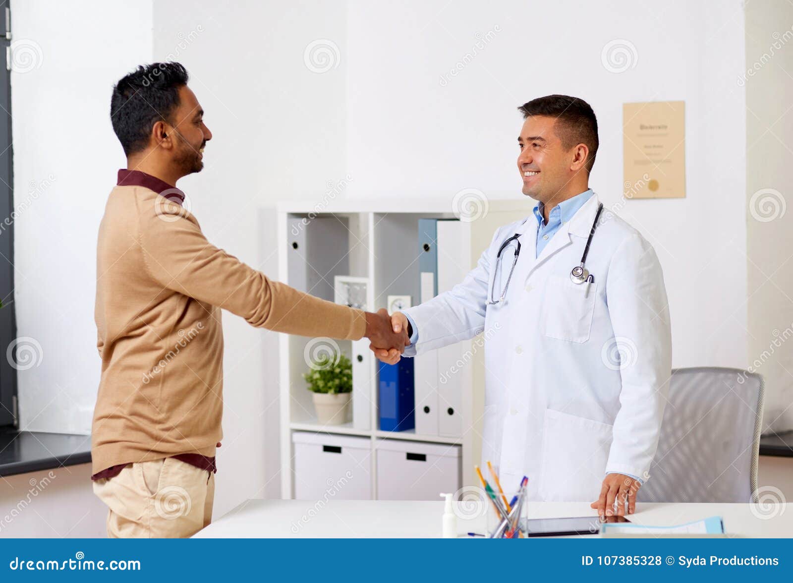 Doctor and Male Patient Shaking Hands at Hospital Stock Photo - Image ... Doctor and Male Patient Shaking Hands at Hospital Stock Photo - Image ...