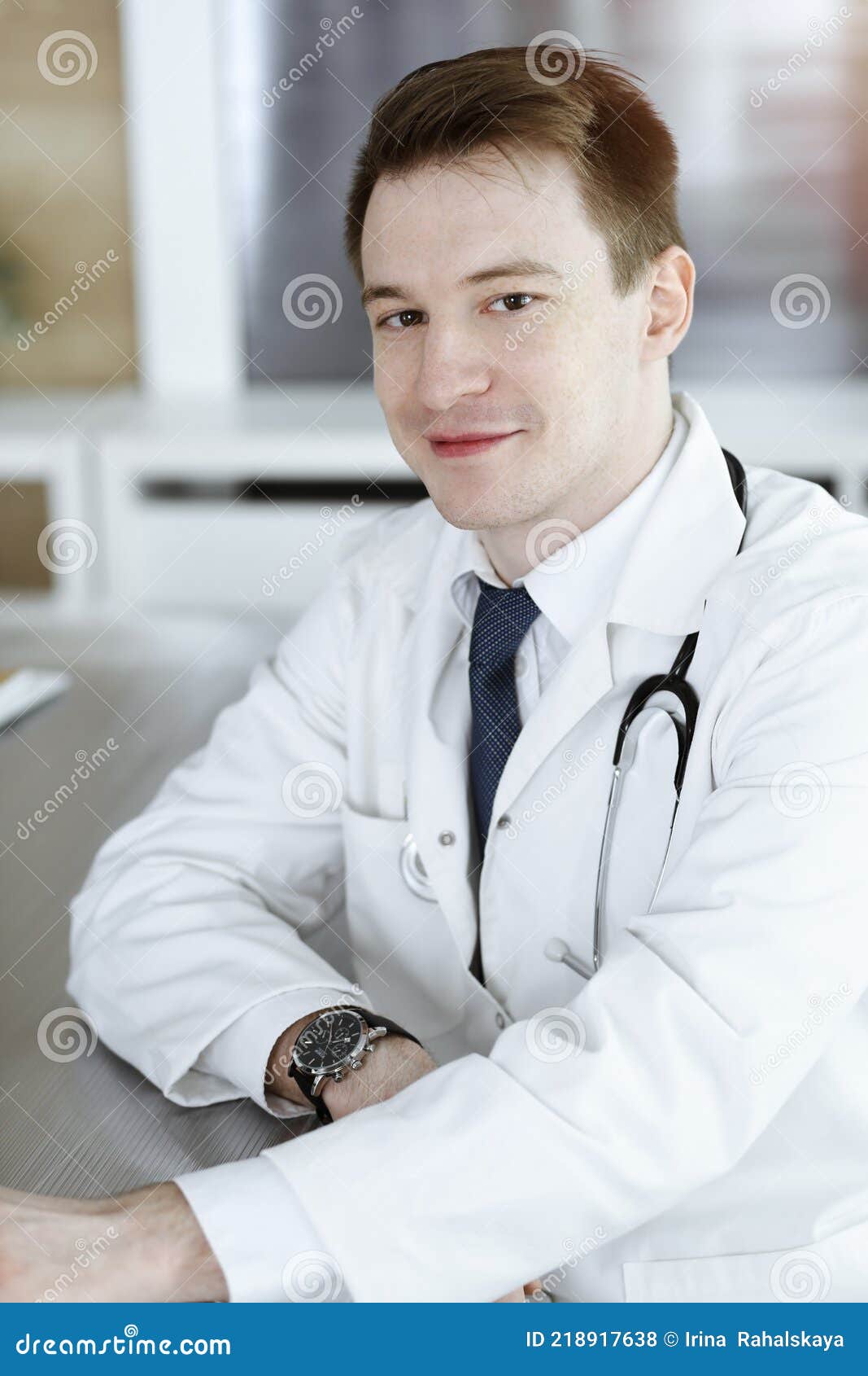 Doctor Man Sitting Behind a Computer at Workplace in Sunny Clinic Stock ...