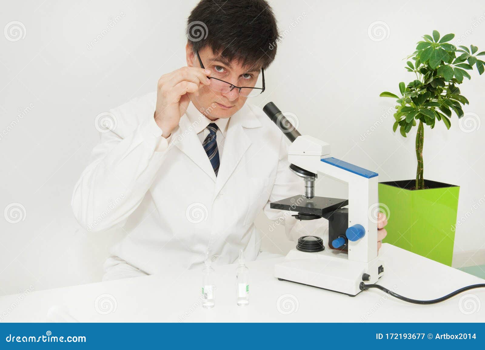 Doctor with a microscope stock image. Image of assistant - 172193677