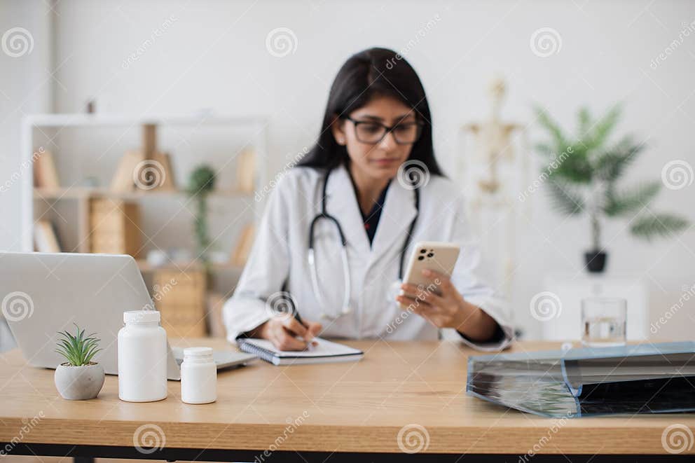 Doctor Noting Data of Patient during Video Call on Mobile Stock Photo ...