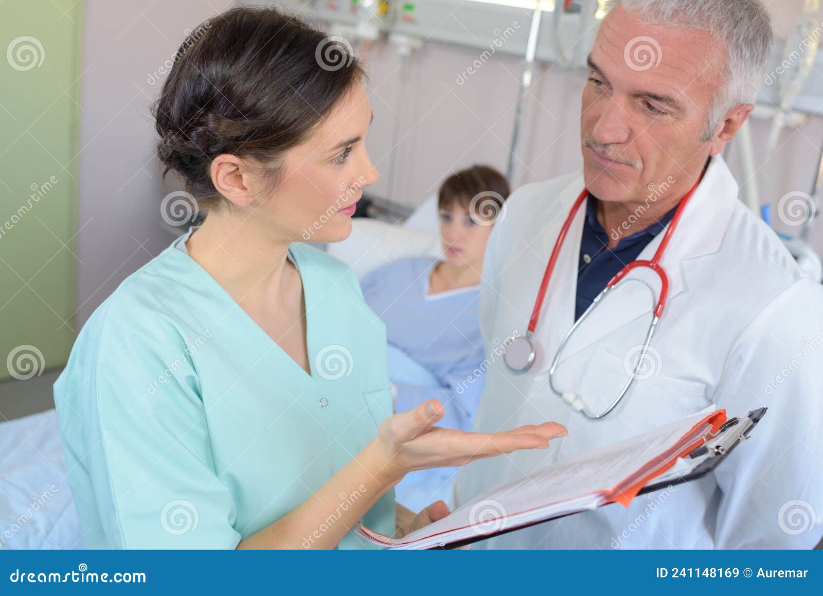 Doctor and Nurse in Discussion at Patient S Bedside Stock Image - Image ...