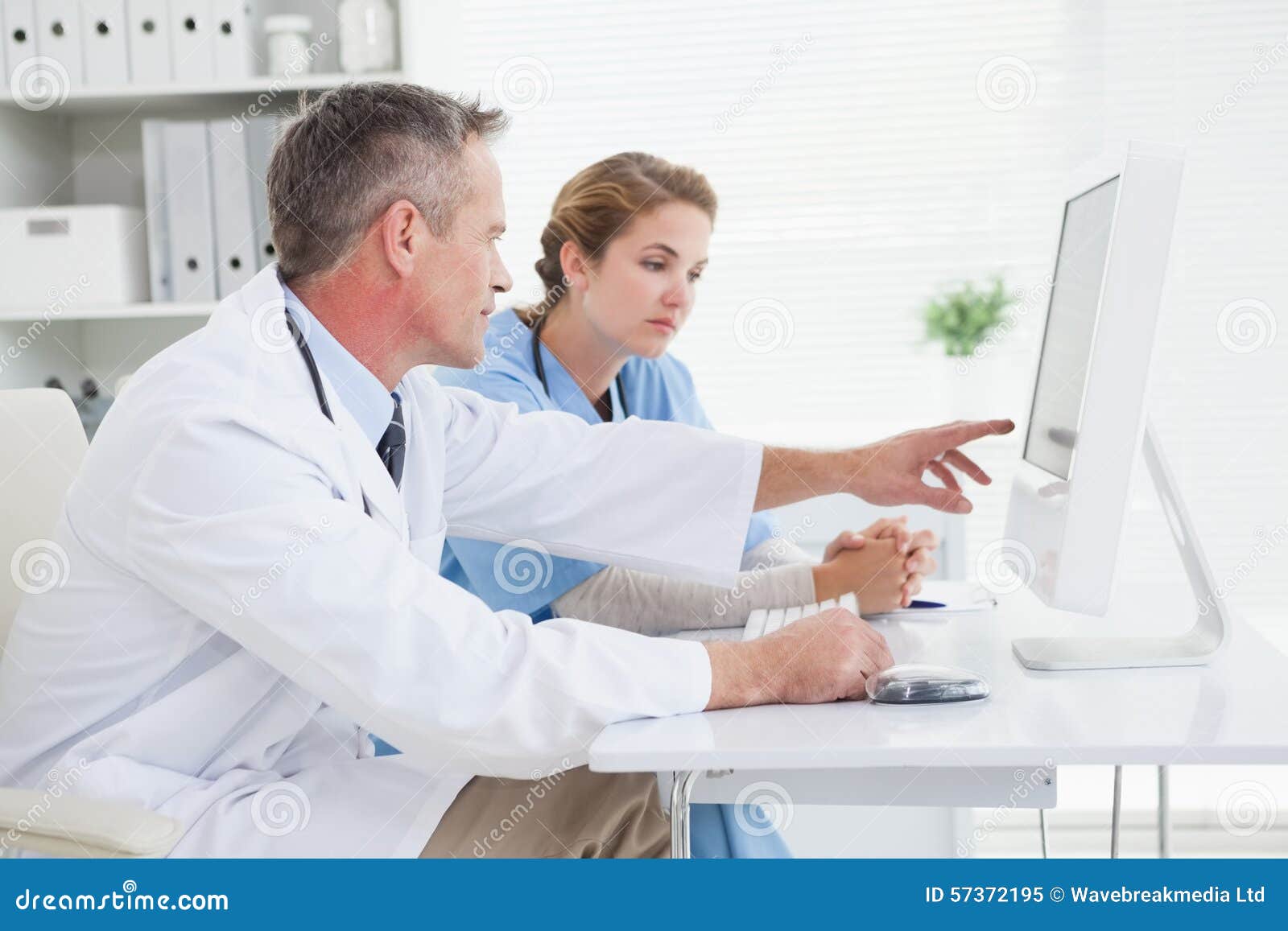 Doctor and Nurse Looking at a Computer Stock Image - Image of adult ...