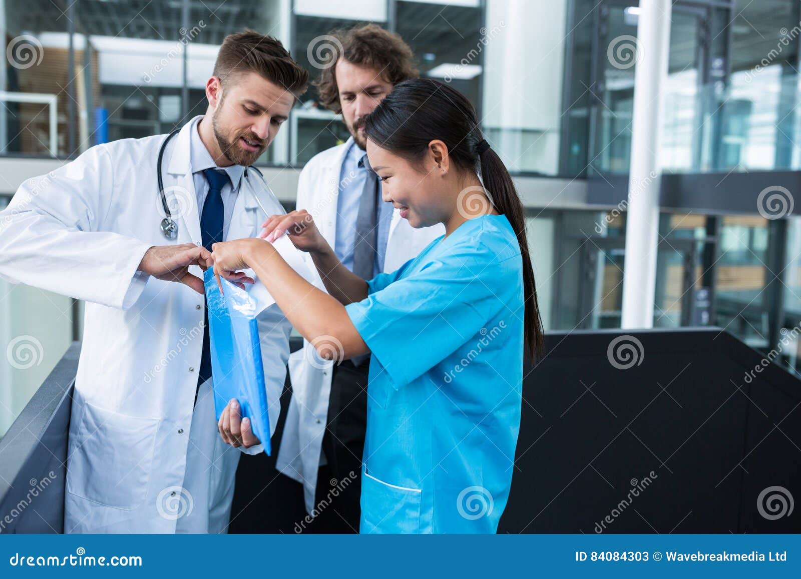 Doctor and Nurse Opening a File Folder Stock Image - Image of ...